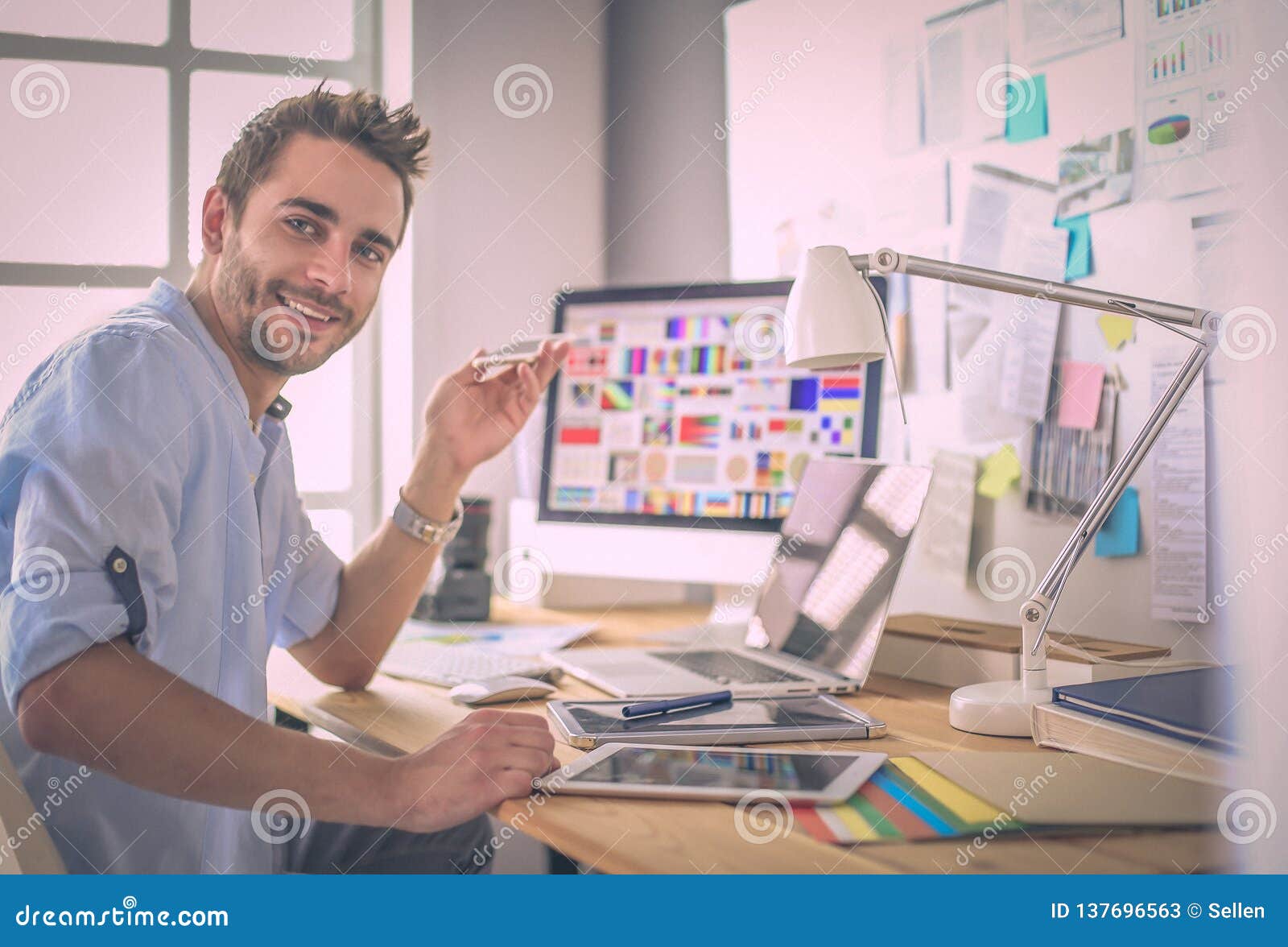 Portrait of Young Designer Sitting at Graphic Studio in Front of Laptop ...