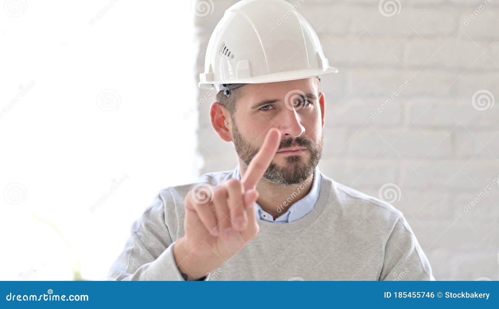 Portrait of Young Engineer Showing No Sign by Finger Stock Photo ...