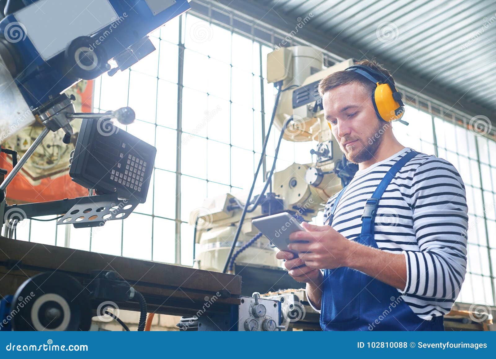 Modern Machine Operator stock photo. Image of unit, hardhat - 102810088