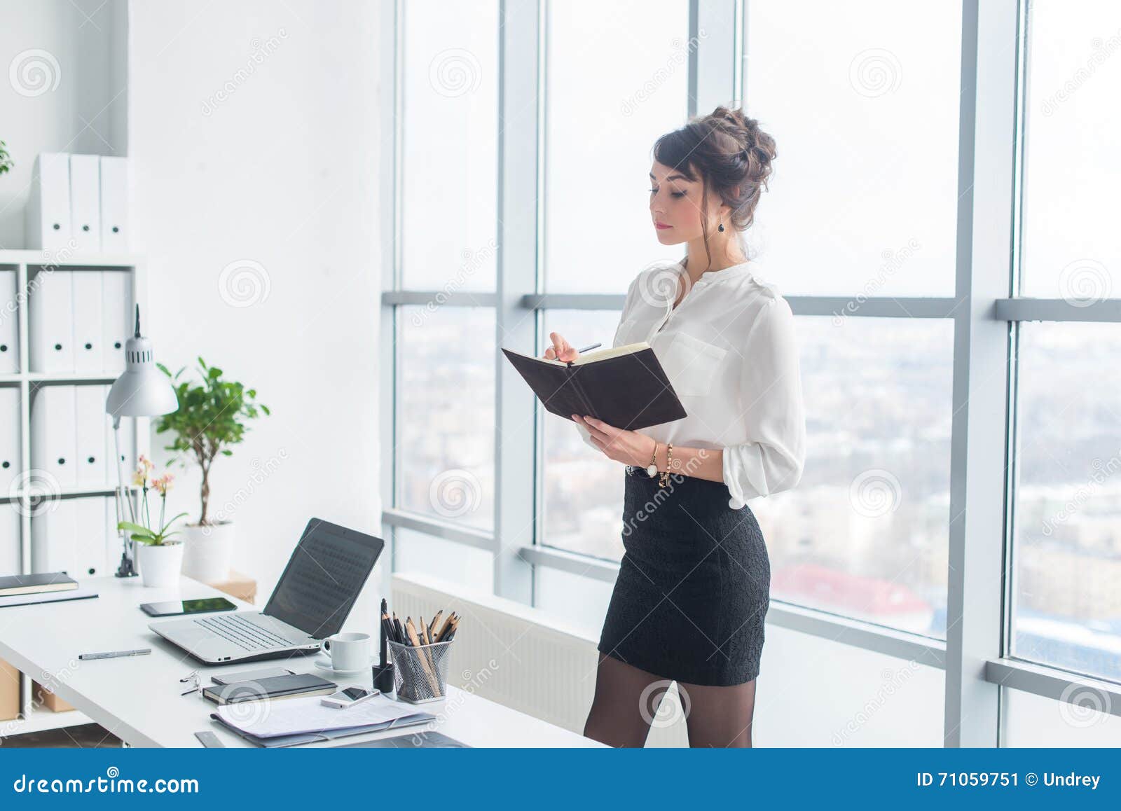 Portrait of a Young Female Assistant Planning Work Day Schedule ...