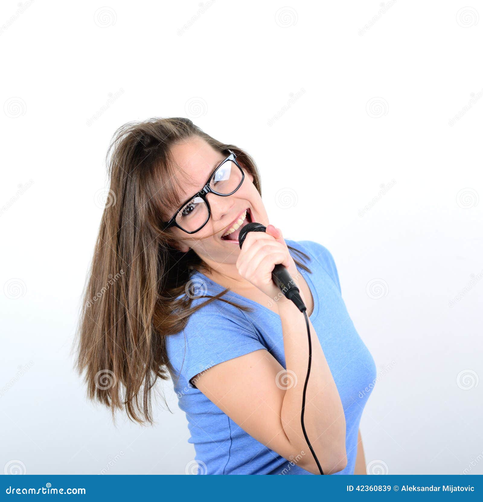 Portrait of a Young Female with Microphone Against White Background ...