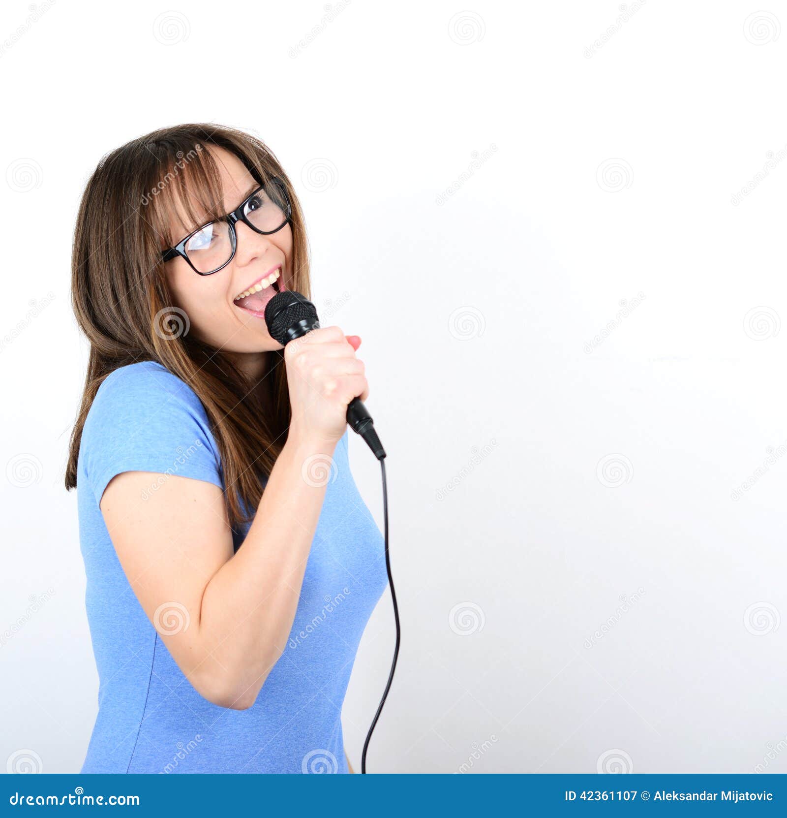 Portrait of a Young Female with Microphone Against White Background ...