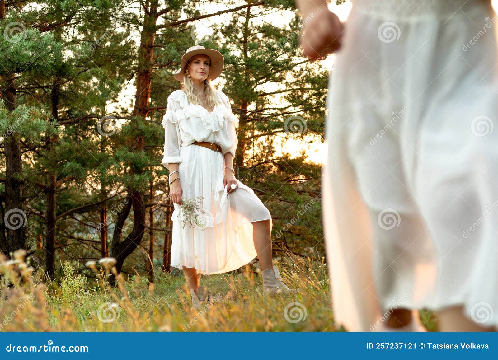 Portrait Of Young Flawless Woman Standing In Front Of Trees In Forest