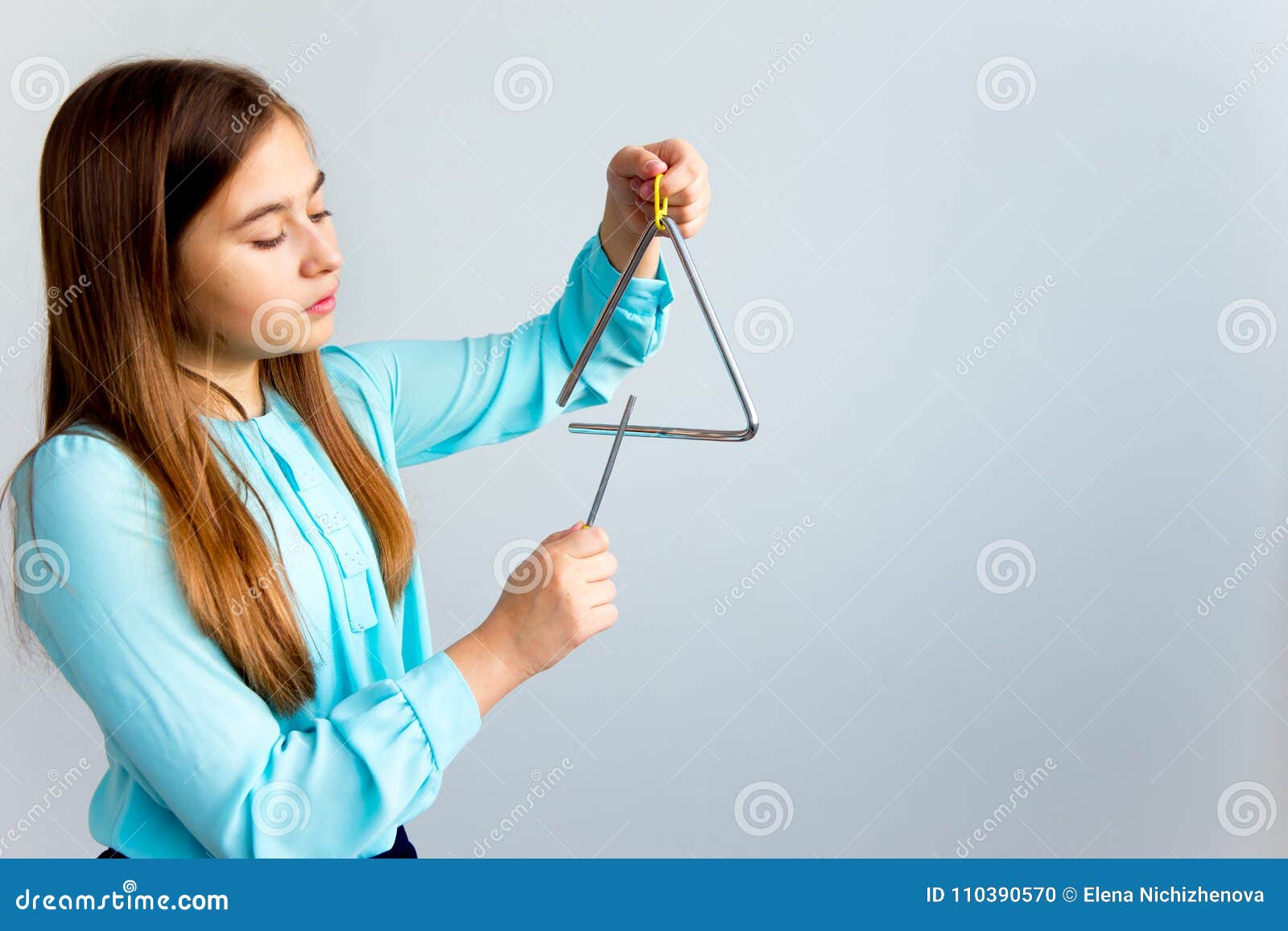 Girl plays a triangle stock photo. Image of hands, hitting - 110390570