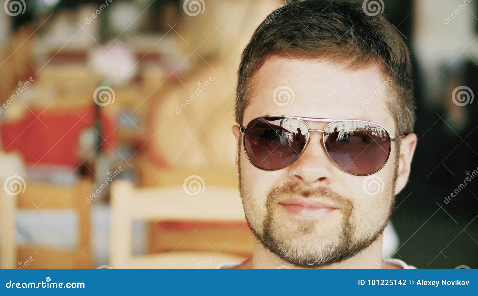 Portrait Of The Young Handsome Bearded Man Wearing Sunglasses Stock