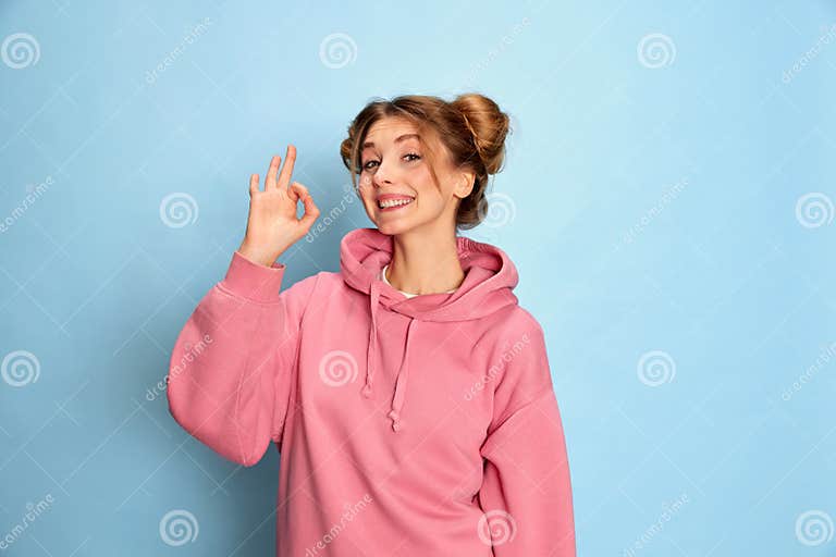 Portrait Of Young Happy Girl In Pink Hoodie Posing With Positive Mood