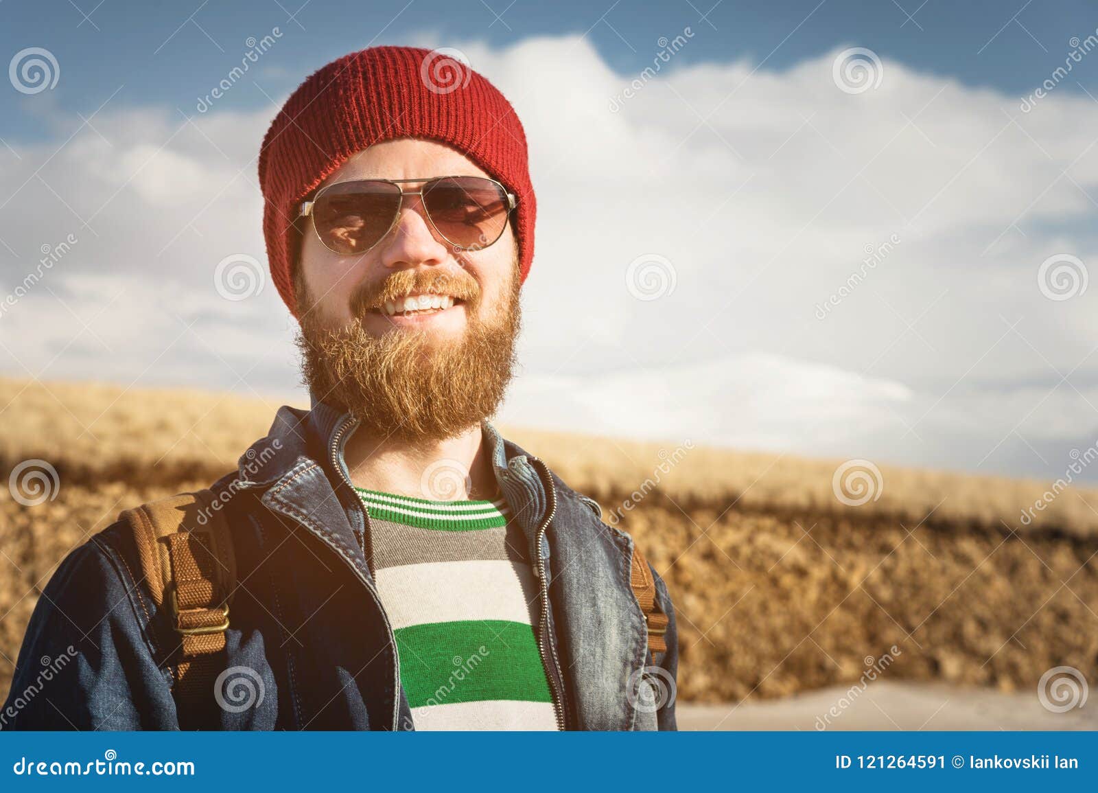 Portrait Of A Young Hipster Man Wearing Sunglasses And A Hat A Smiling