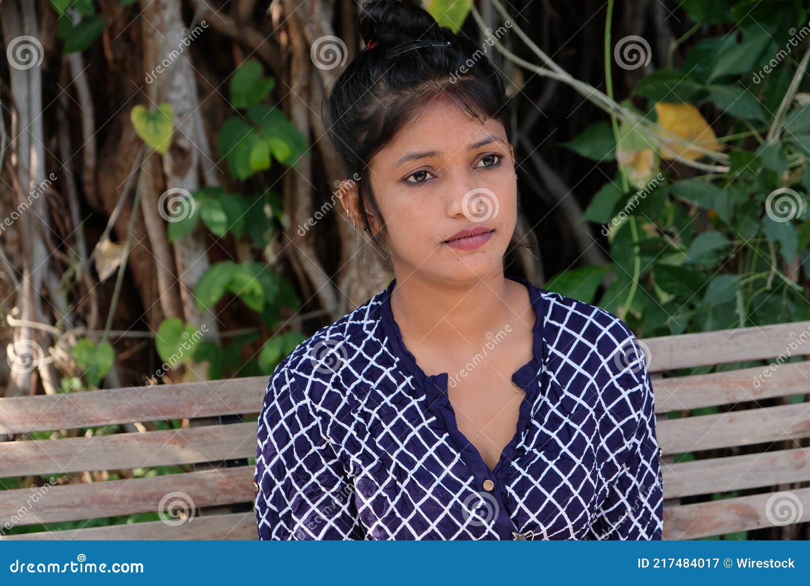 Portrait of a Young Indian Female Sitting on a Bench Stock Image ...