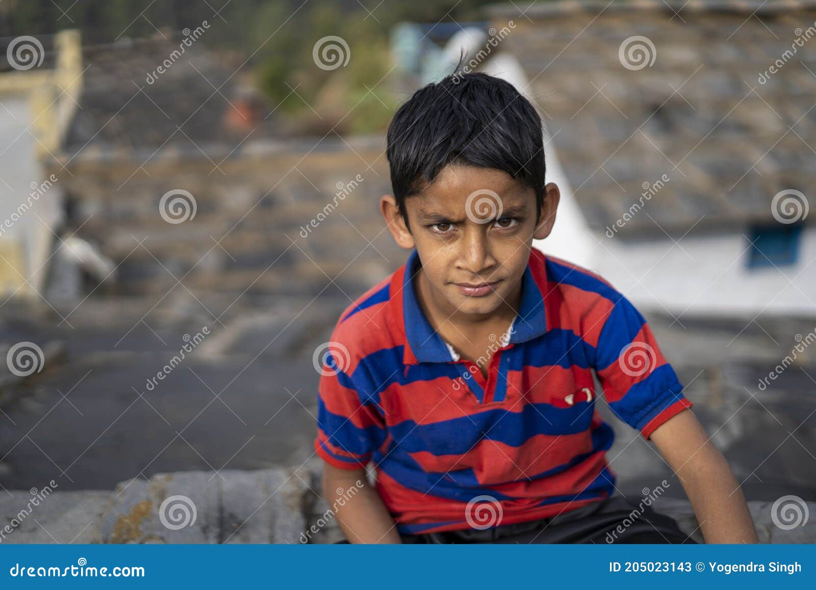 Portrait of a Young Kid Looking into the Camera, with Blurred Mountains ...
