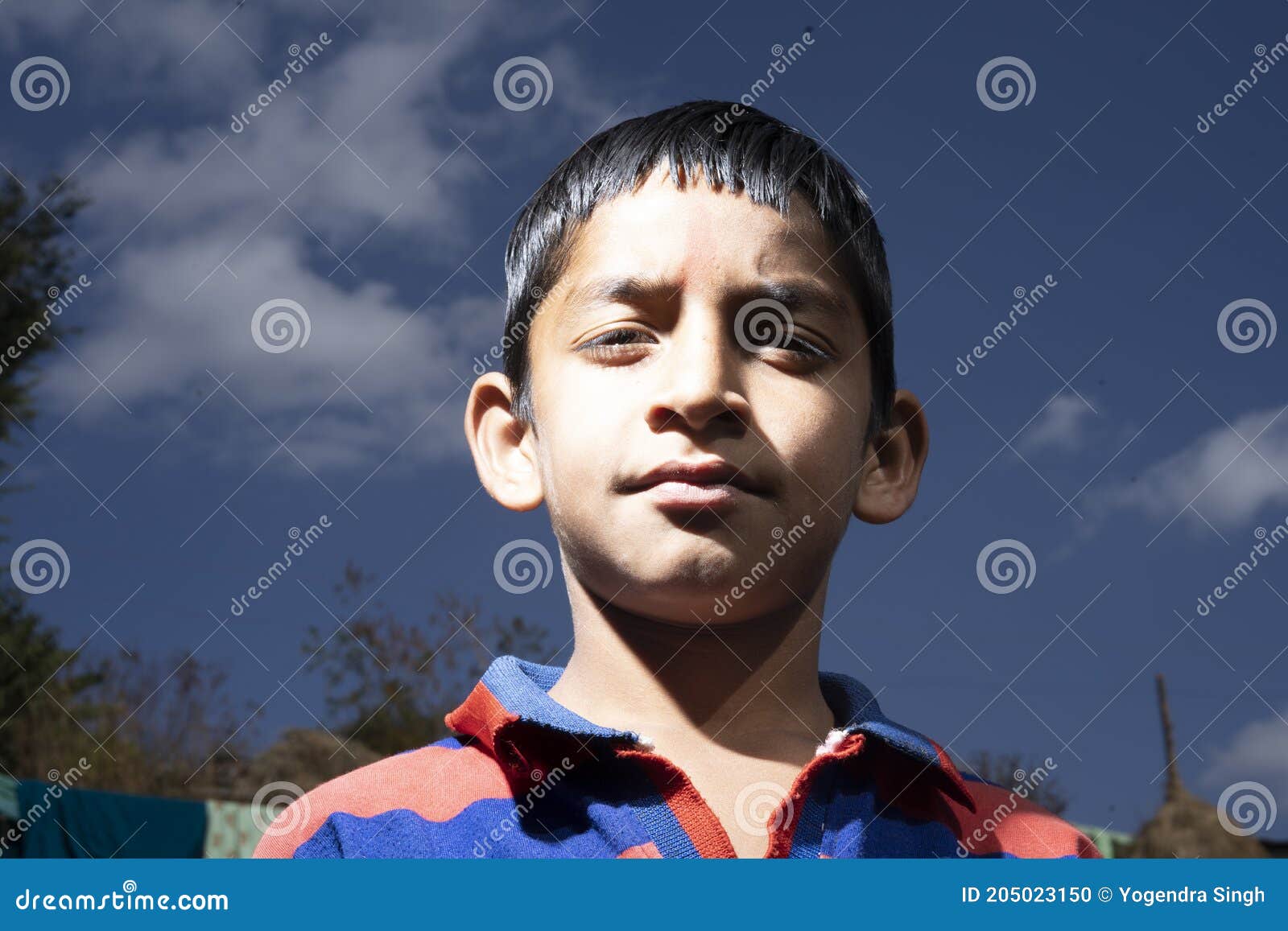 Portrait of a Young Kid Looking into the Camera, with Blurred Mountains ...