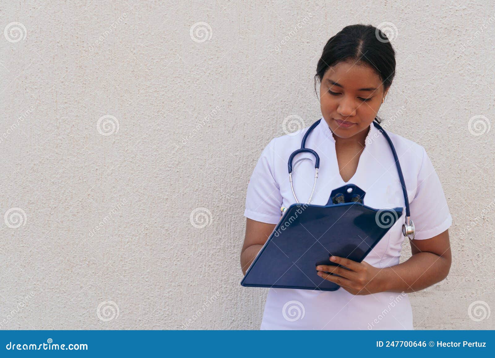 Portrait of a Young Latina Doctor Taking Notes Stock Photo - Image of ...