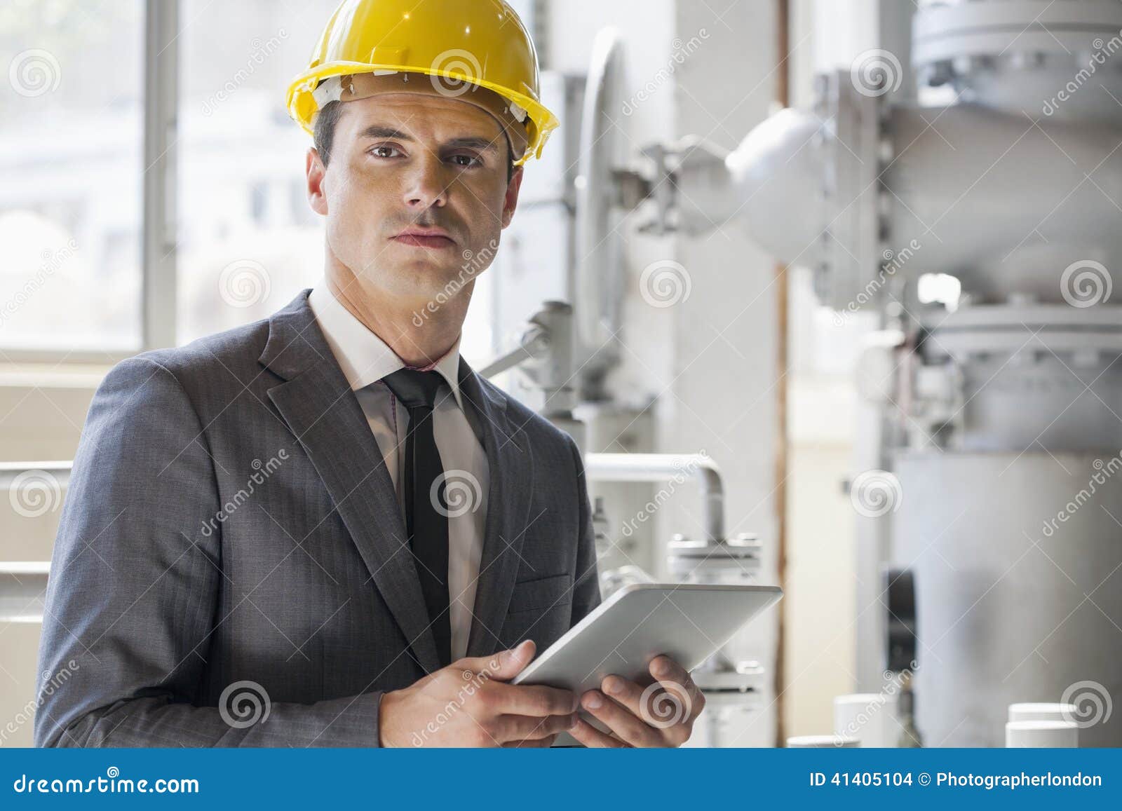 Portrait of Young Male Architect Holding Tablet Computer in Industry ... Portrait of Young Male Architect Holding Tablet Computer in Industry ...