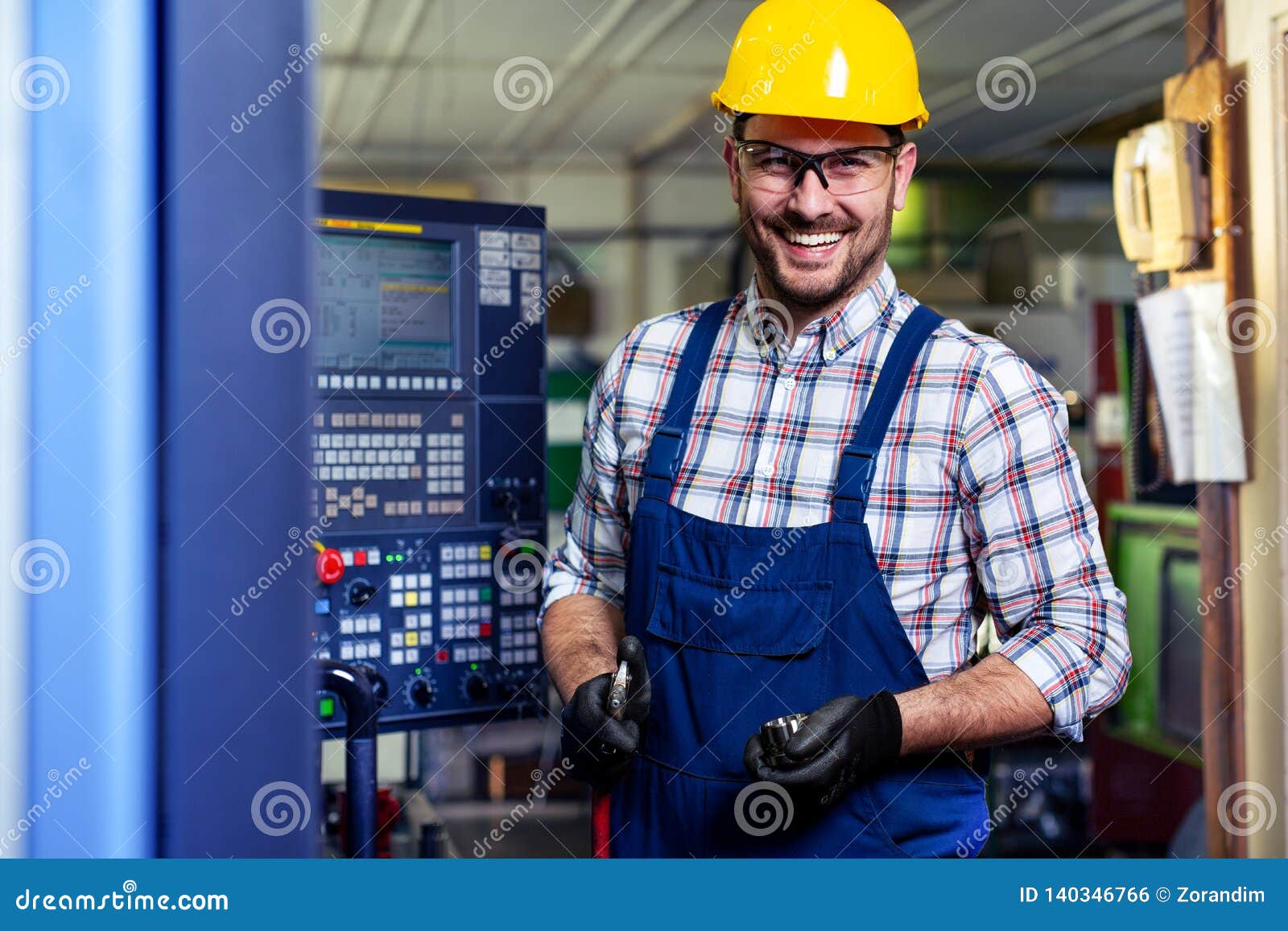 Portrait of Male Engineer Operating CNC Machinery in Factory Stock ... Portrait of Male Engineer Operating CNC Machinery in Factory Stock ...