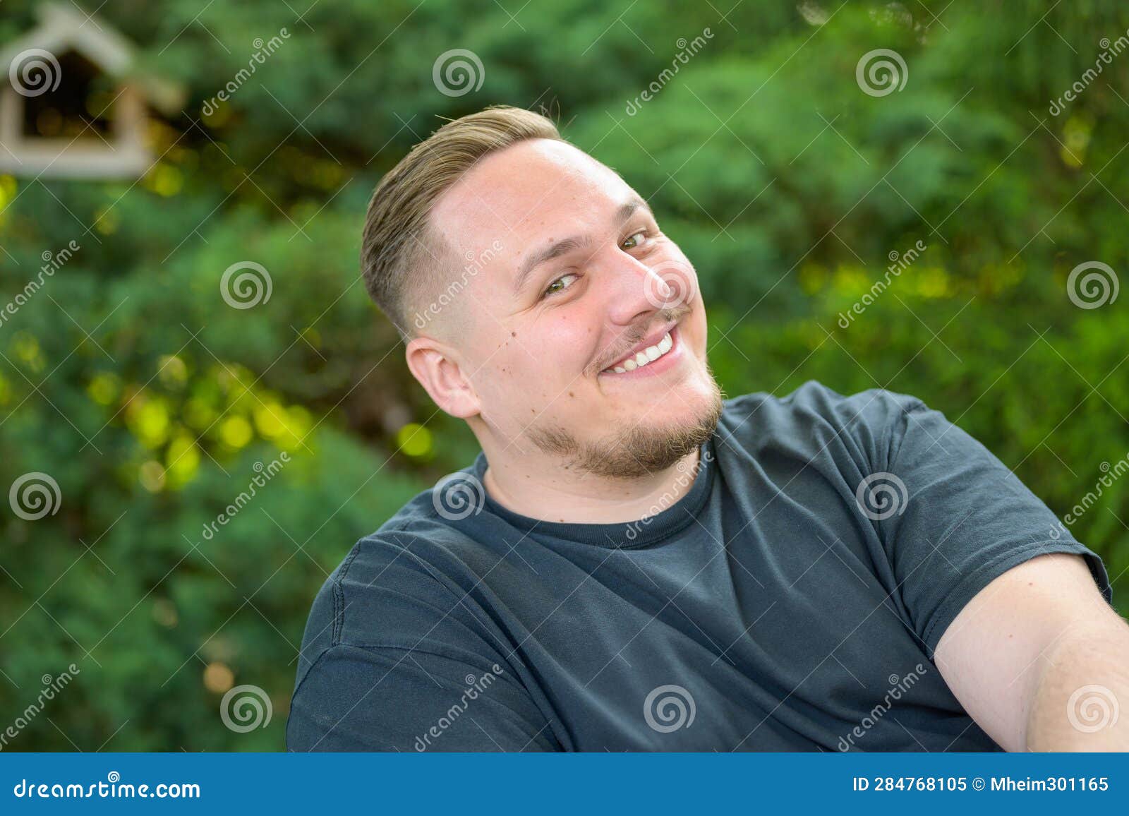 Portrait of a Young Man with a Beard Sitting in the Garden Stock Image ...