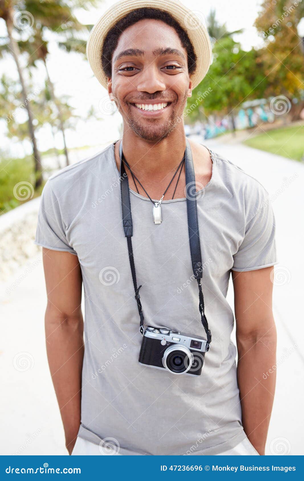Portrait of Young Man Carrying Camera Stock Photo - Image of holiday ...
