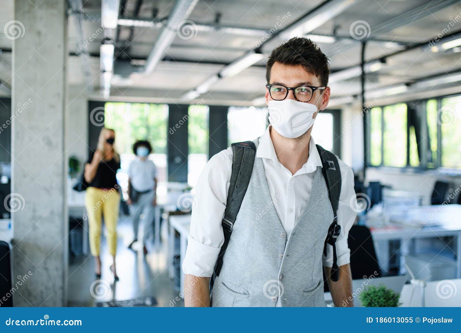 Portrait of Young Man with Face Mask Back at Work in Office after ...