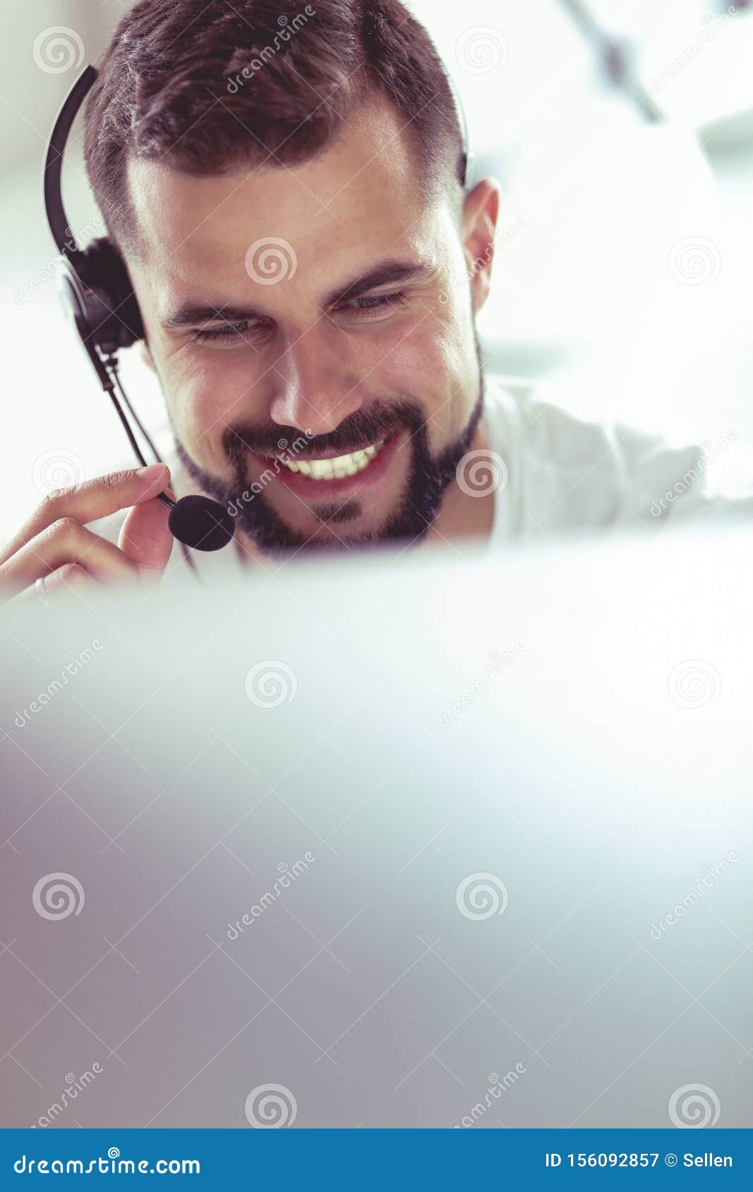 Portrait of a Young Man with a Headset in Front of a Laptop Computer ...