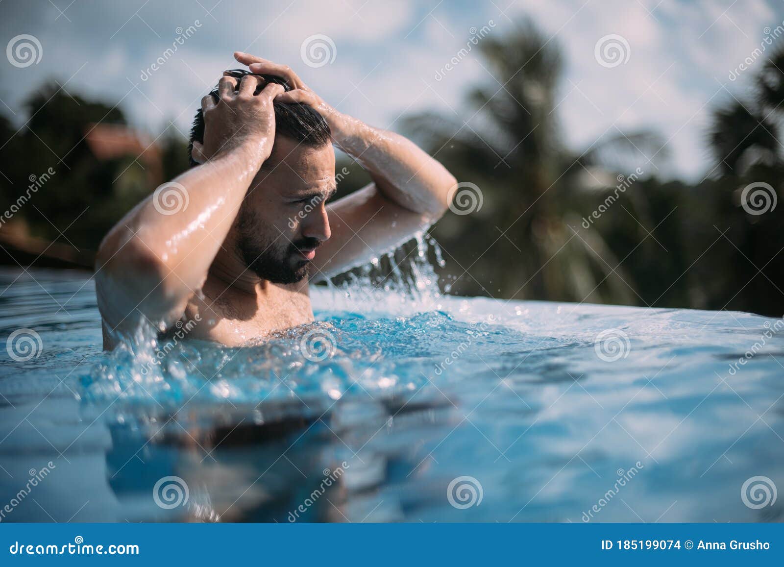 Portrait of a Young Man in an Outdoor Pool. Attractive Guy with a Beard ...