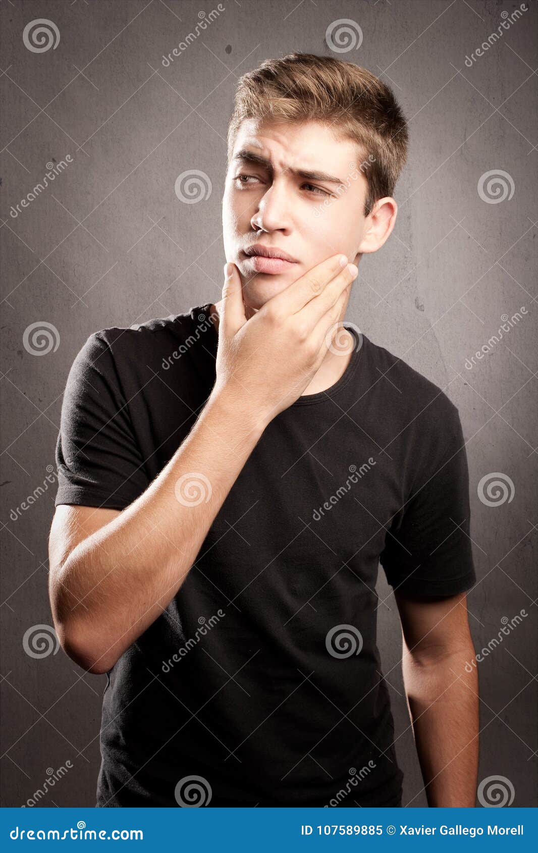 Young Man with Pensive Expression Stock Image - Image of gesturing ...