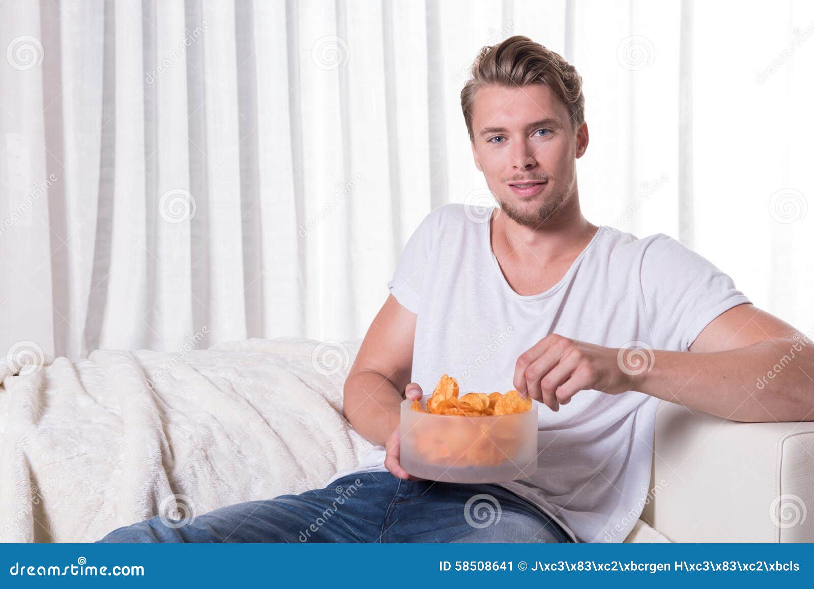 Portrait Young Man Sitting on Couch and Eating Chips Stock Image ...