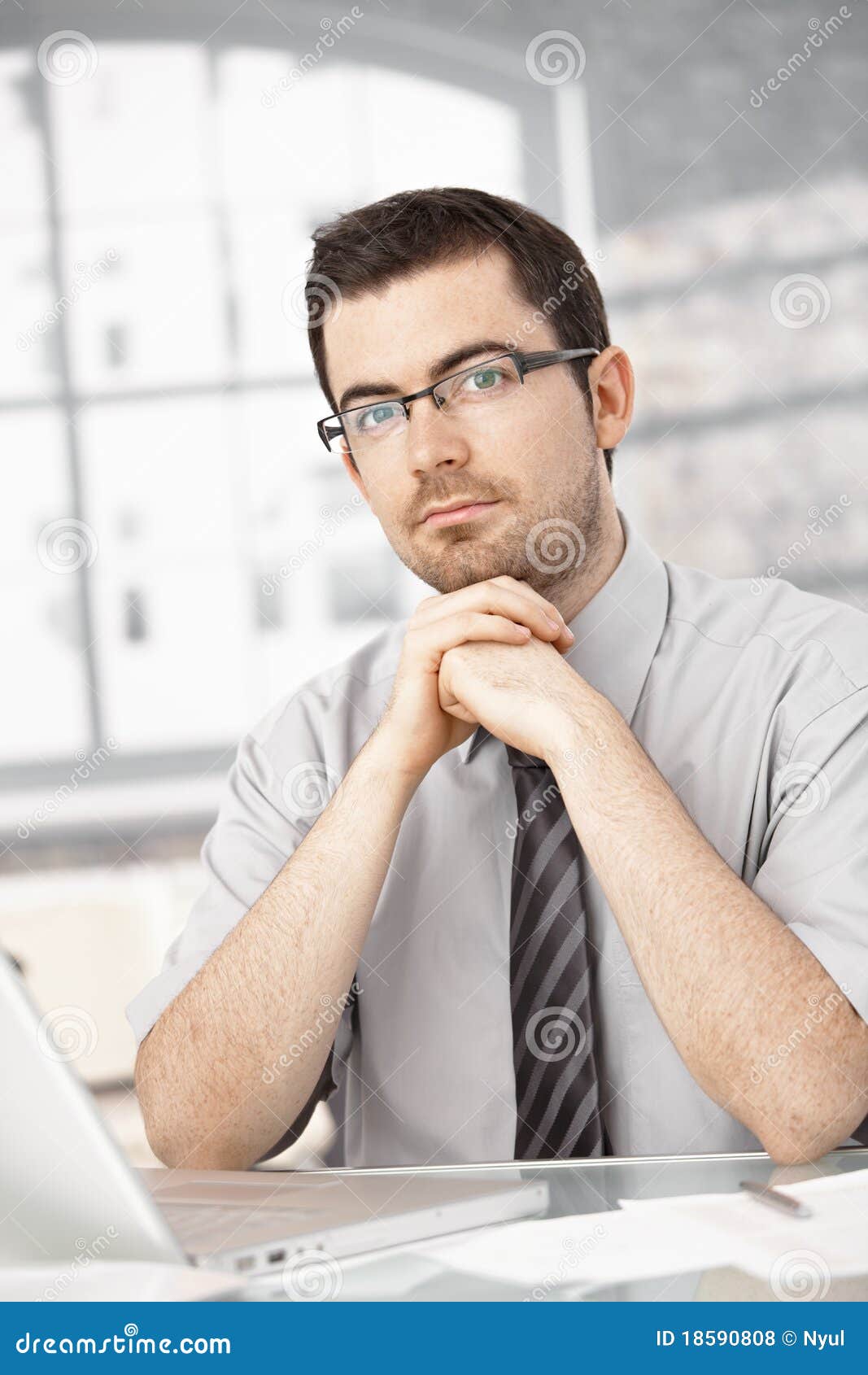 Portrait of Young Man Sitting at Desk Using Laptop Stock Photo - Image ...