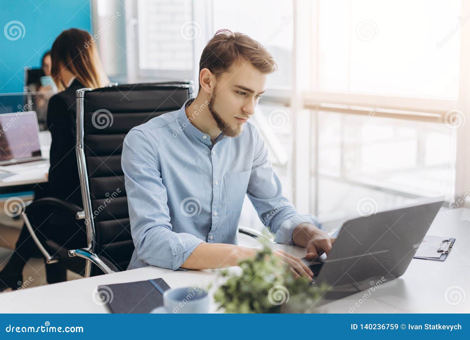 Portrait of Young Man Sitting at His Desk in the Office Stock Image ... Portrait of Young Man Sitting at His Desk in the Office Stock Image ...