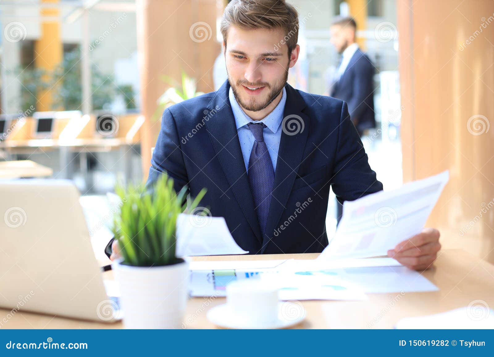Portrait of Young Man Sitting at His Desk in the Office. Stock Photo ...