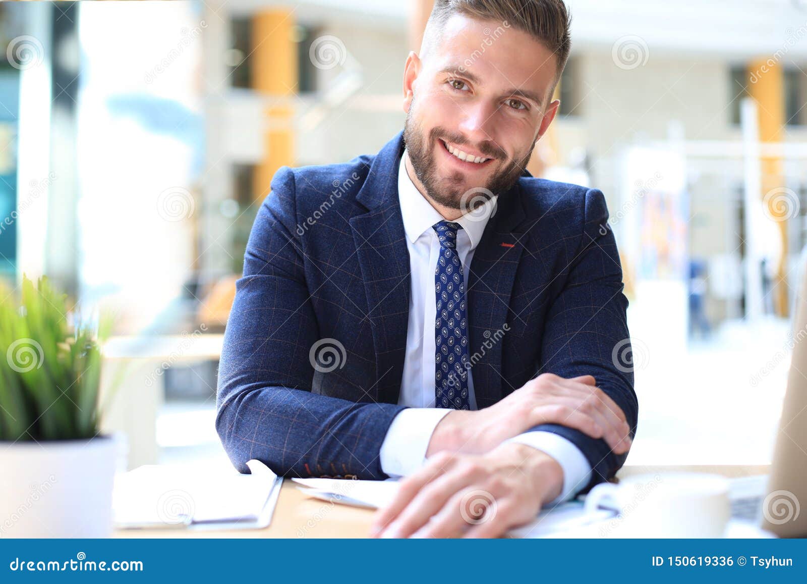 Portrait of Young Man Sitting at His Desk in the Office. Stock Photo ...