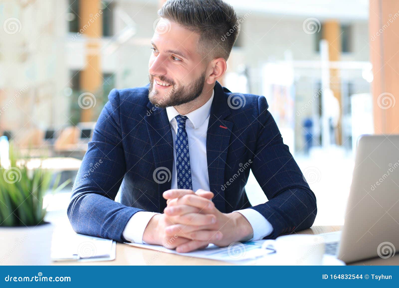 Portrait of Young Man Sitting at His Desk in the Office Stock Photo ...