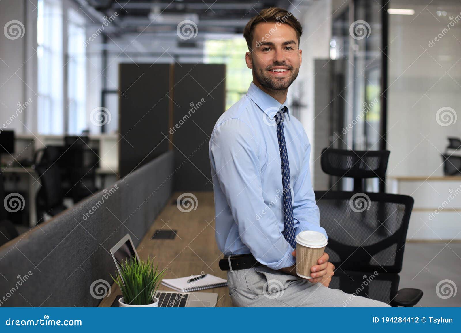 Portrait of Young Man Sitting at His Desk in the Office Stock Photo ...