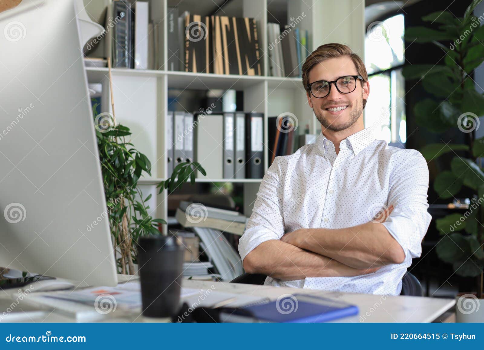 Portrait of Young Man Sitting at His Desk in the Office. Stock Image ...
