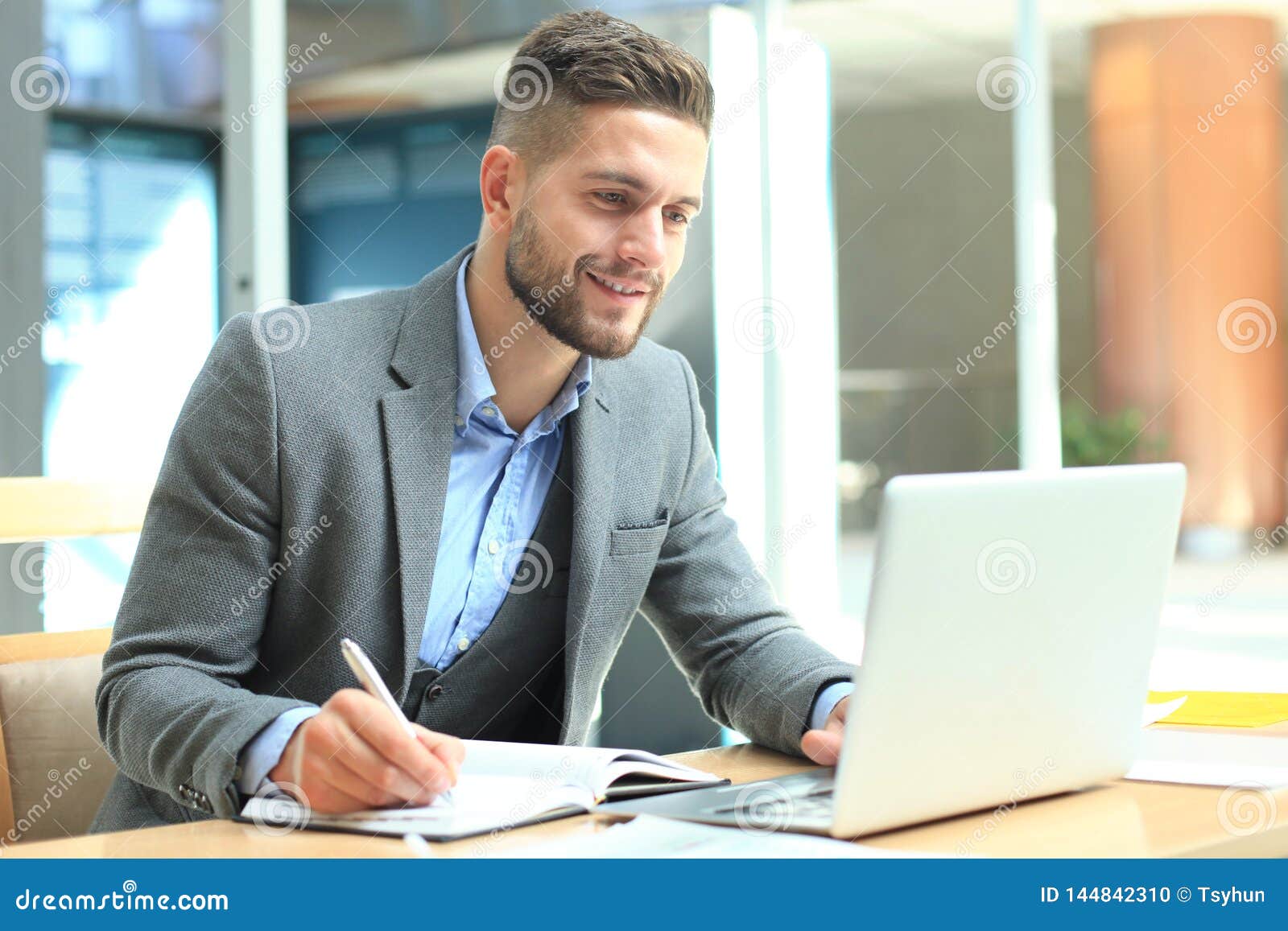 Portrait of Young Man Sitting at His Desk in the Office Stock Photo ... Portrait of Young Man Sitting at His Desk in the Office Stock Photo ...