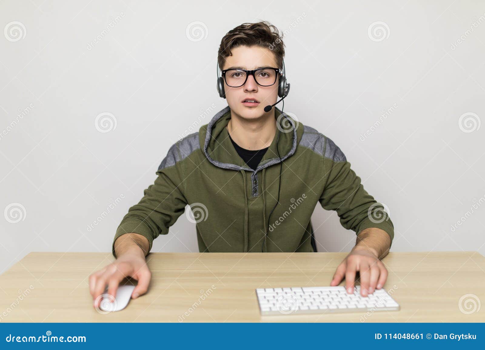 Portrait of Young Man at Table with Hands on Keyboard and Mouse. Front ...