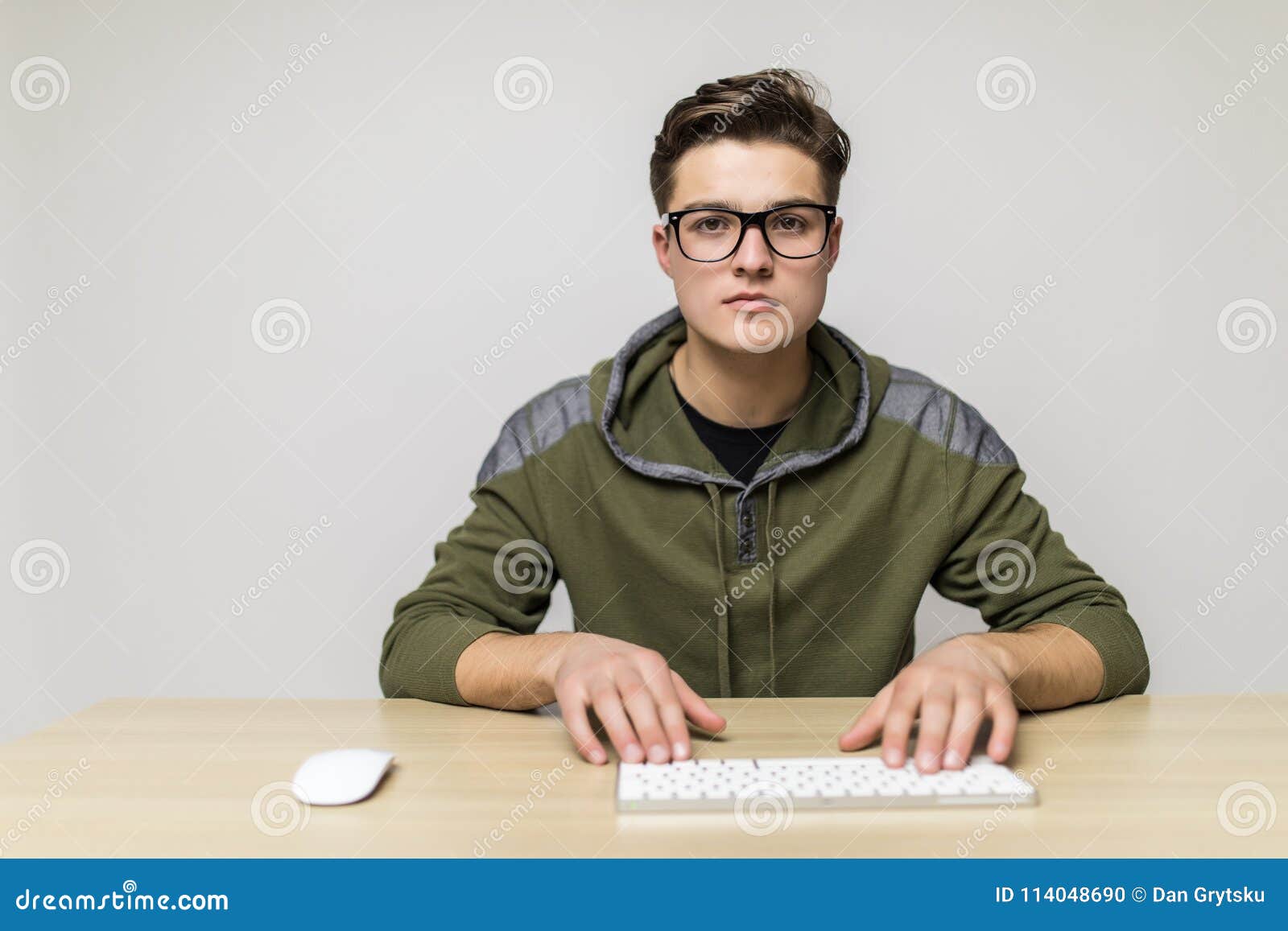 Portrait of Young Man at Table with Hands on Keyboard and Mouse. Front ...