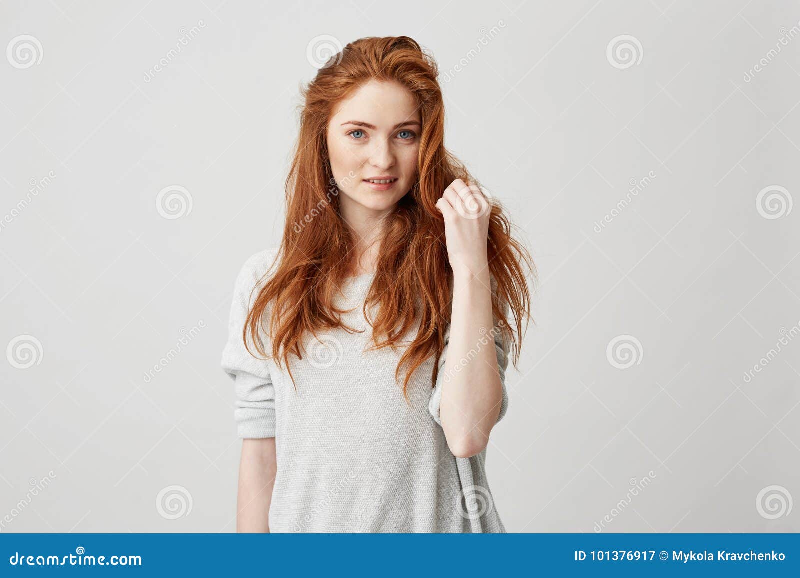 Portrait Of Young Pretty Redhead Girl With Freckles Looking At Camera