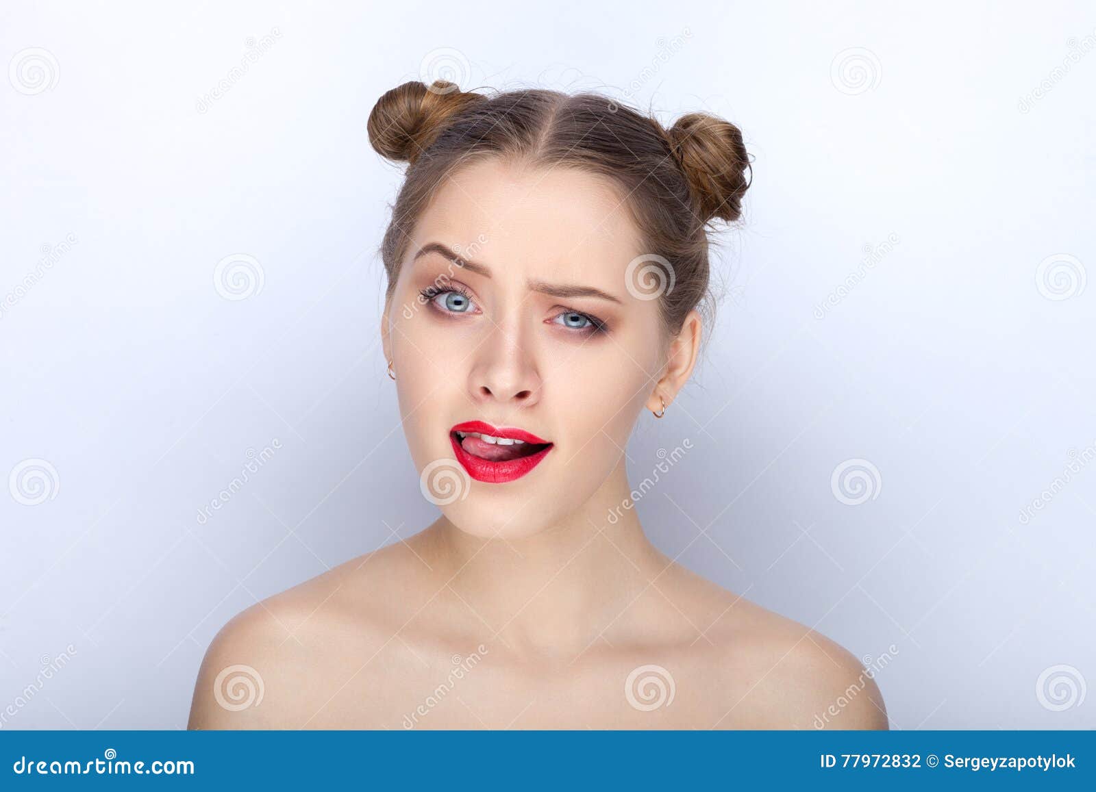 Portrait Of A Young Pretty Woman With Trendy Makeup Bright Red Lips Funny Bun Hairstyle And Bare