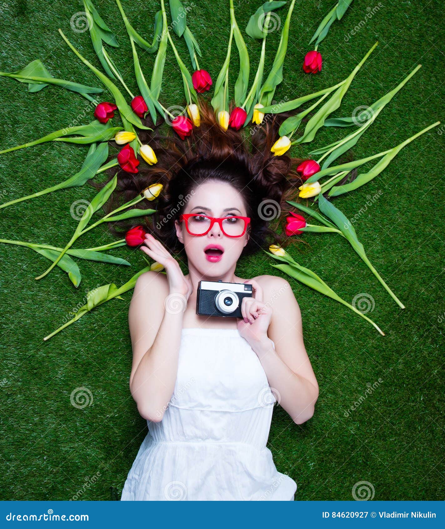 Portrait Of A Young Redhead Woman With Camera And Tulips Stock Image