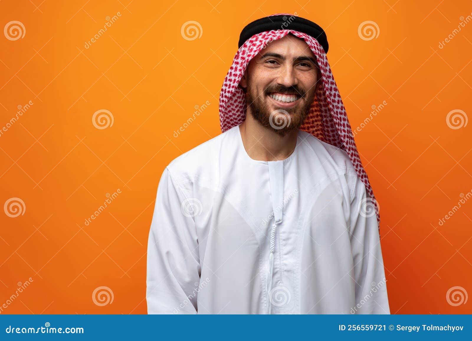Portrait of Young Smiling Arab Man on Orange Background Stock Image ...