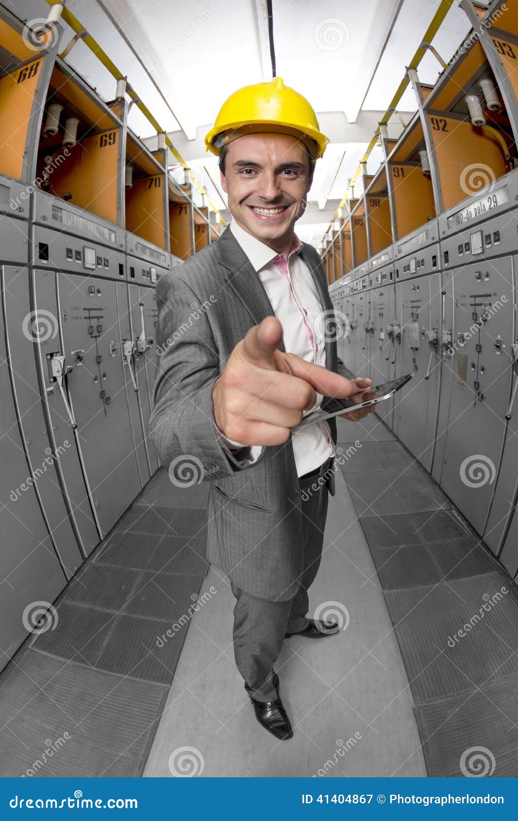 Portrait of Young Smiling Supervisor with Tablet PC Pointing at You in ...
