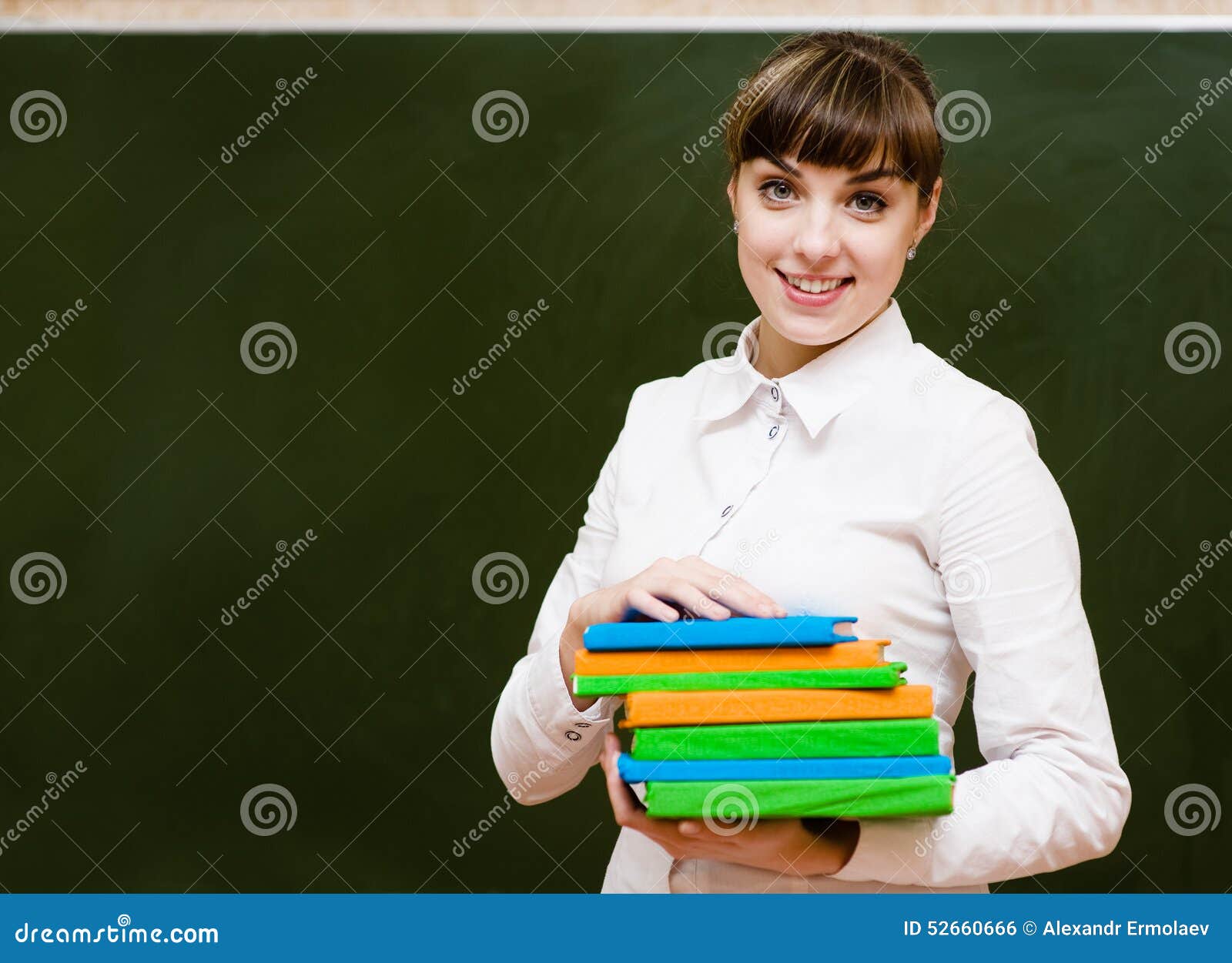 Portrait of Young Teacher with Books. Looking at Camera Stock Photo ...