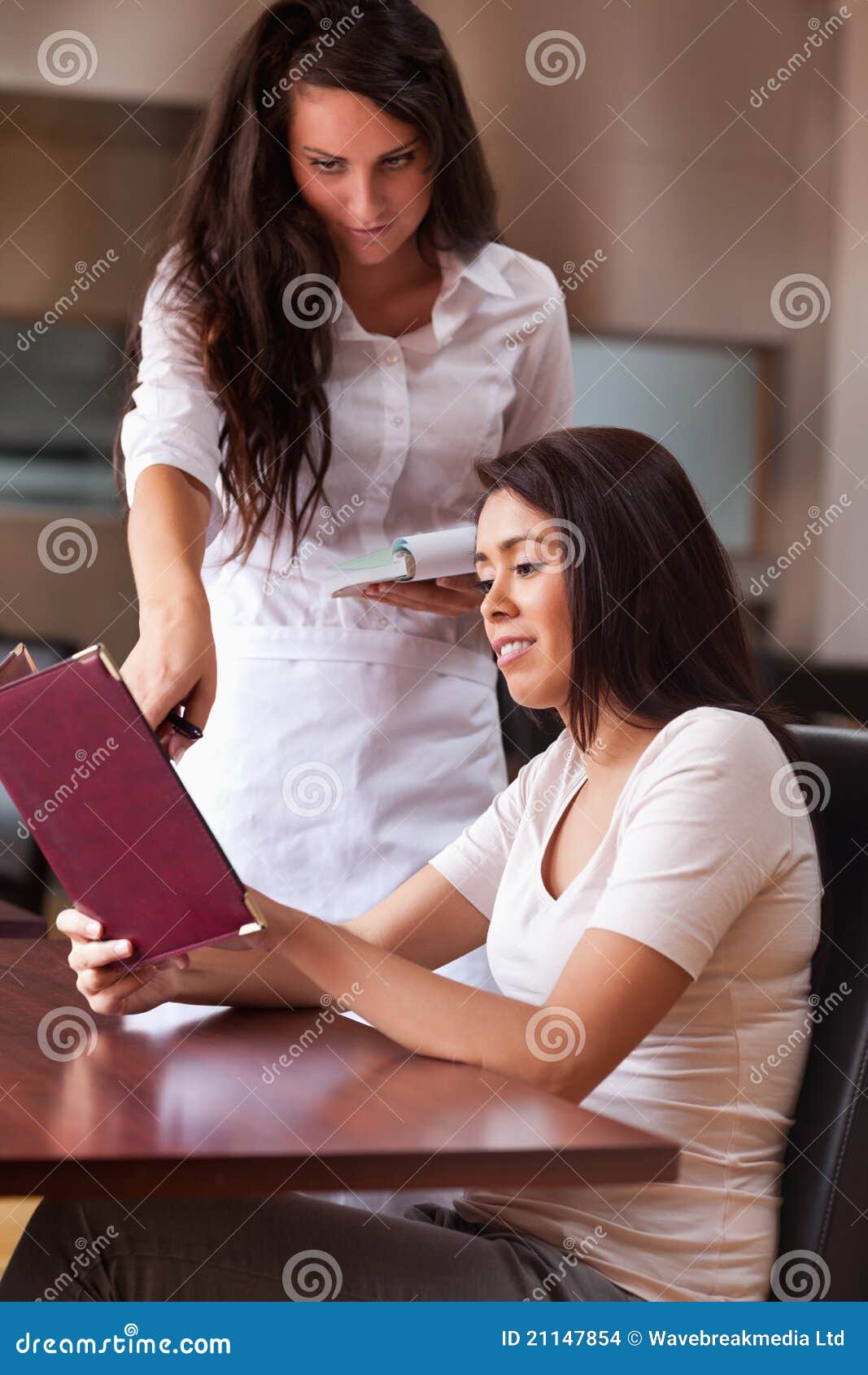 Portrait of a Young Waitress Advising a Customer Stock Photo - Image of ...