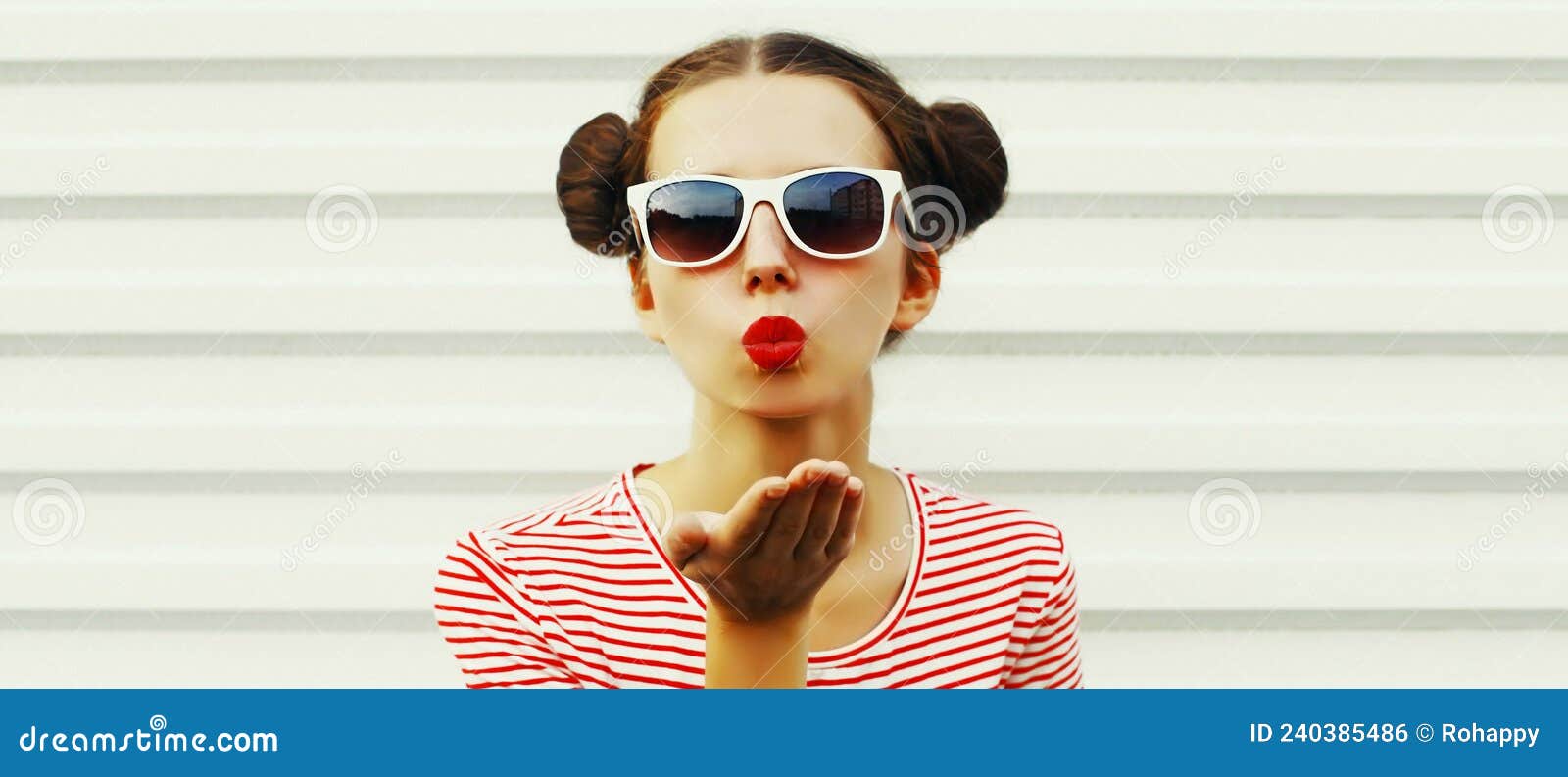 Portrait Of Young Woman Blowing Her Lips Sending Sweet Air Kiss With