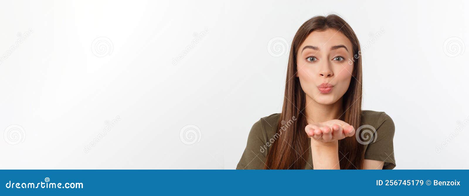 Portrait Of A Young Woman Blowing A Kiss Isolated Over White Stock