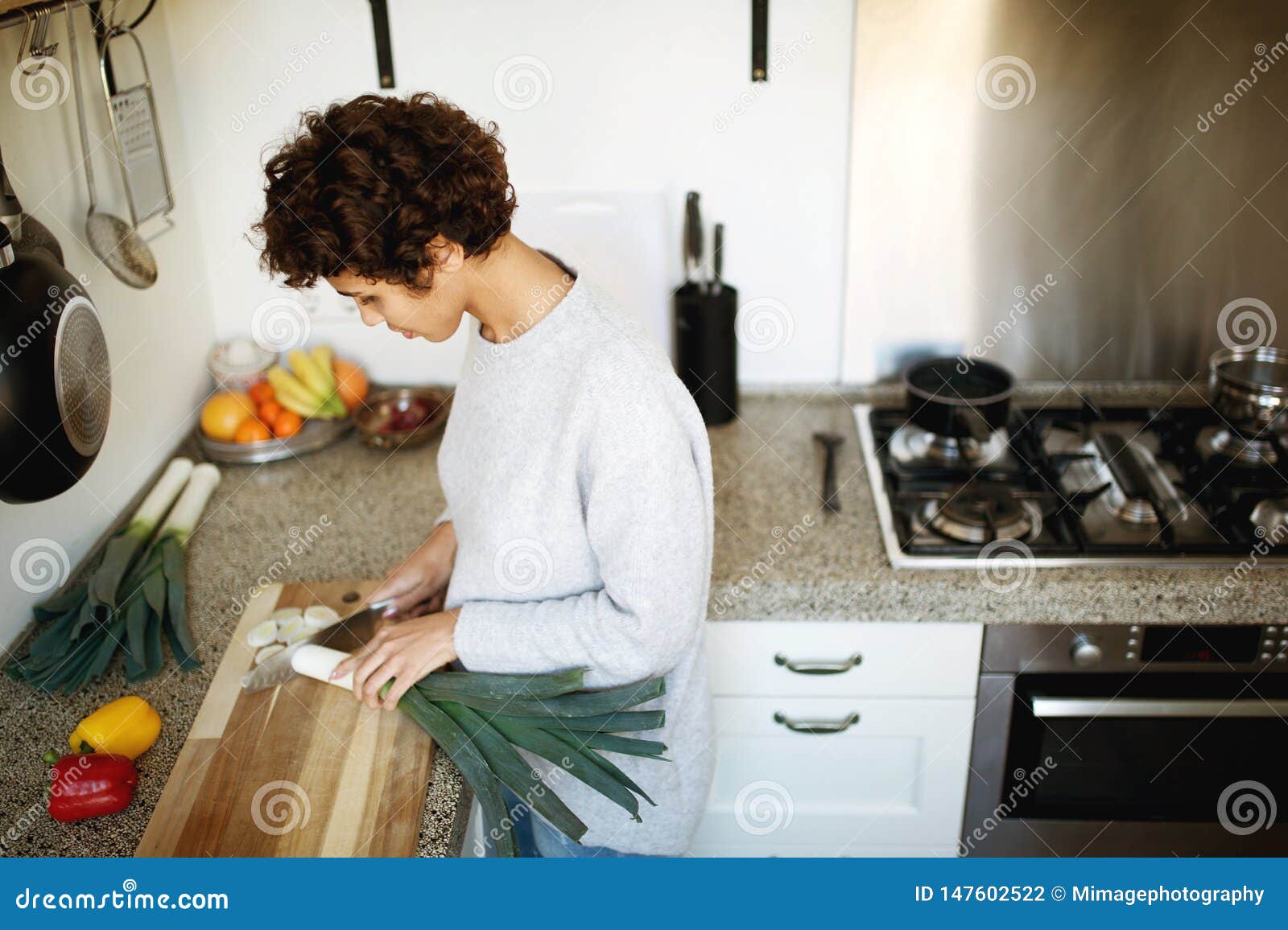 Young Woman Chopping Vegetables in Kitchen Stock Photo - Image of black ...