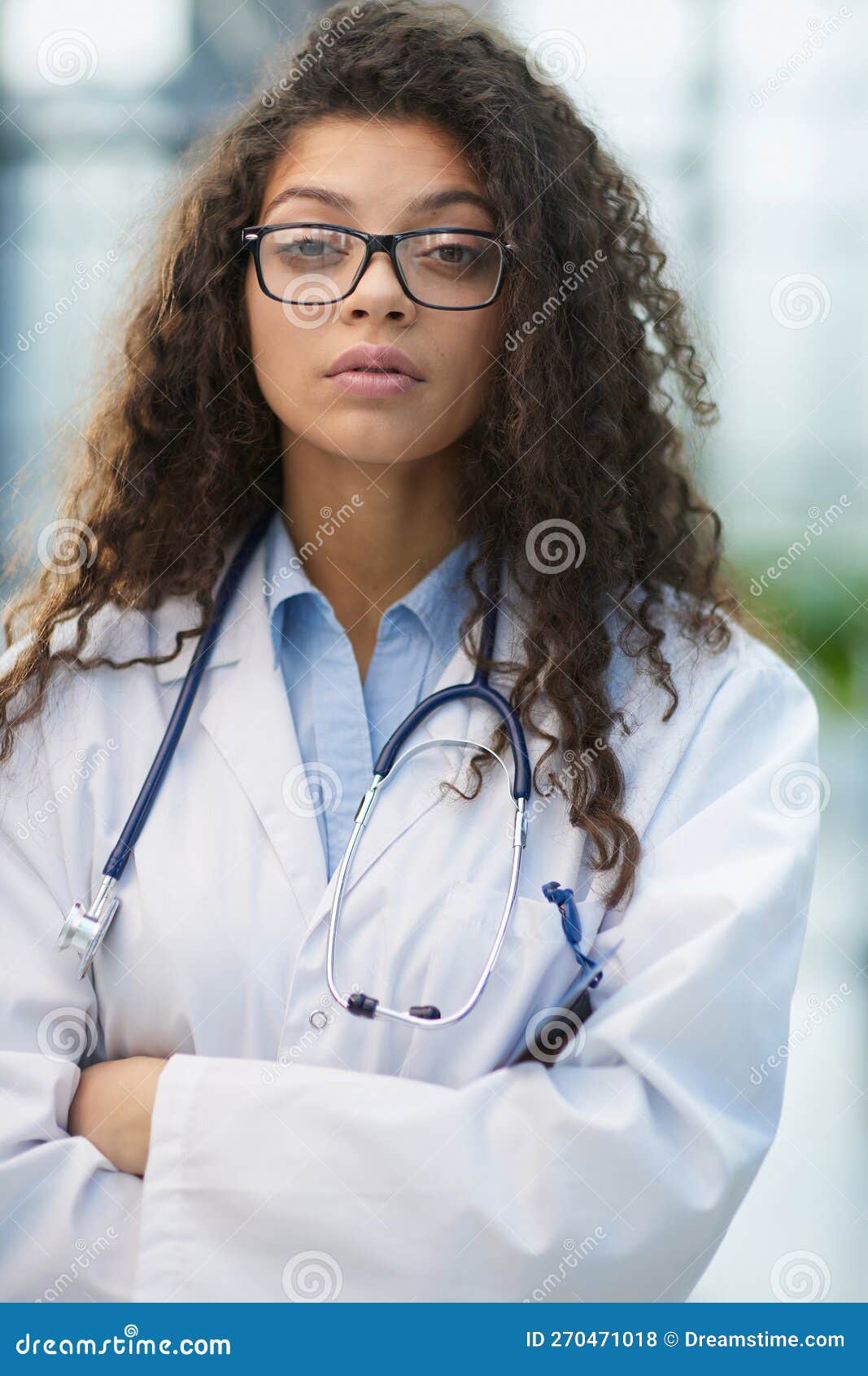 Portrait Of Young Woman Doctor With White Coat Standing In Hospital
