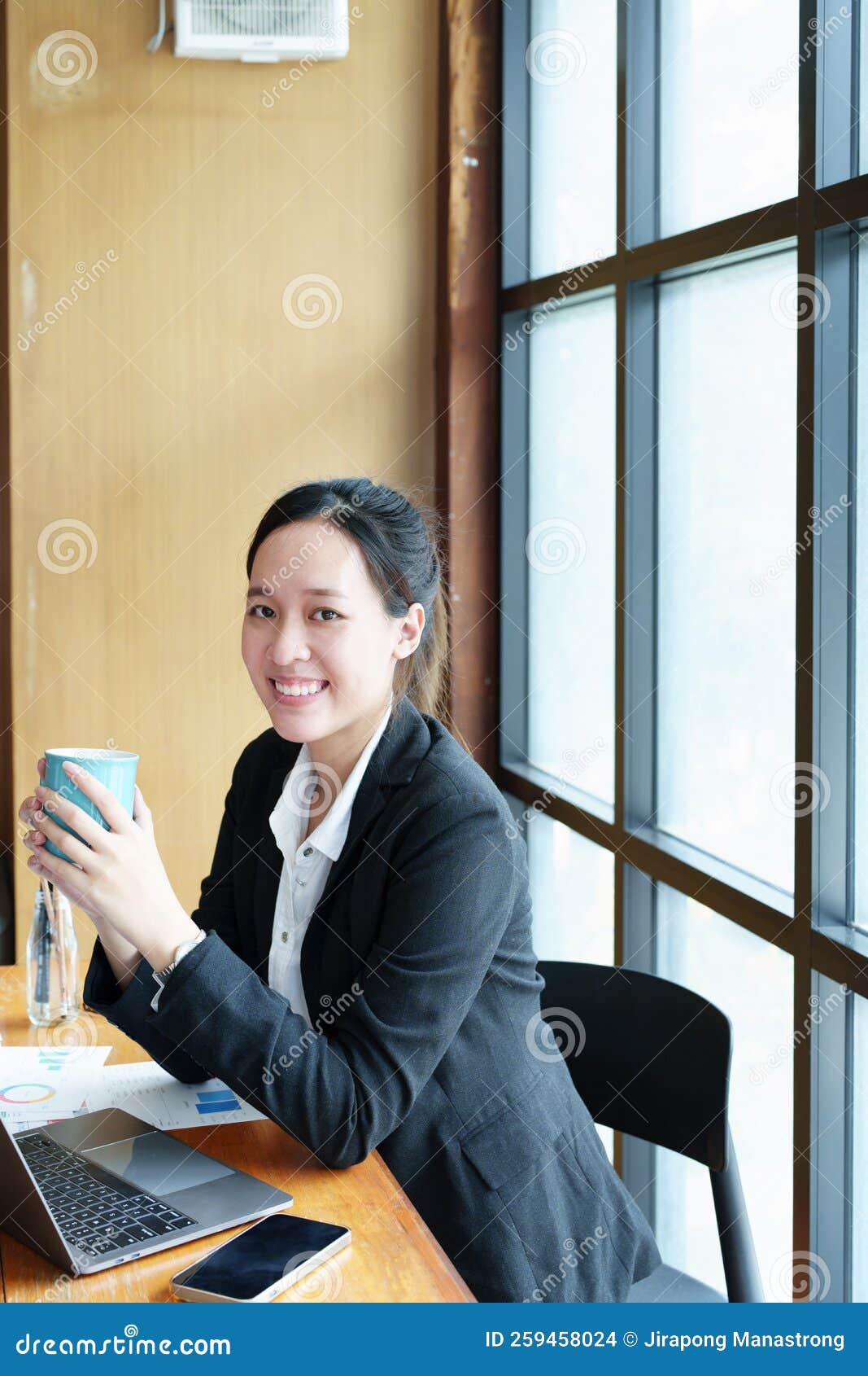 Portrait of a Young Woman Drinking Coffee while Using a Computer Stock ...