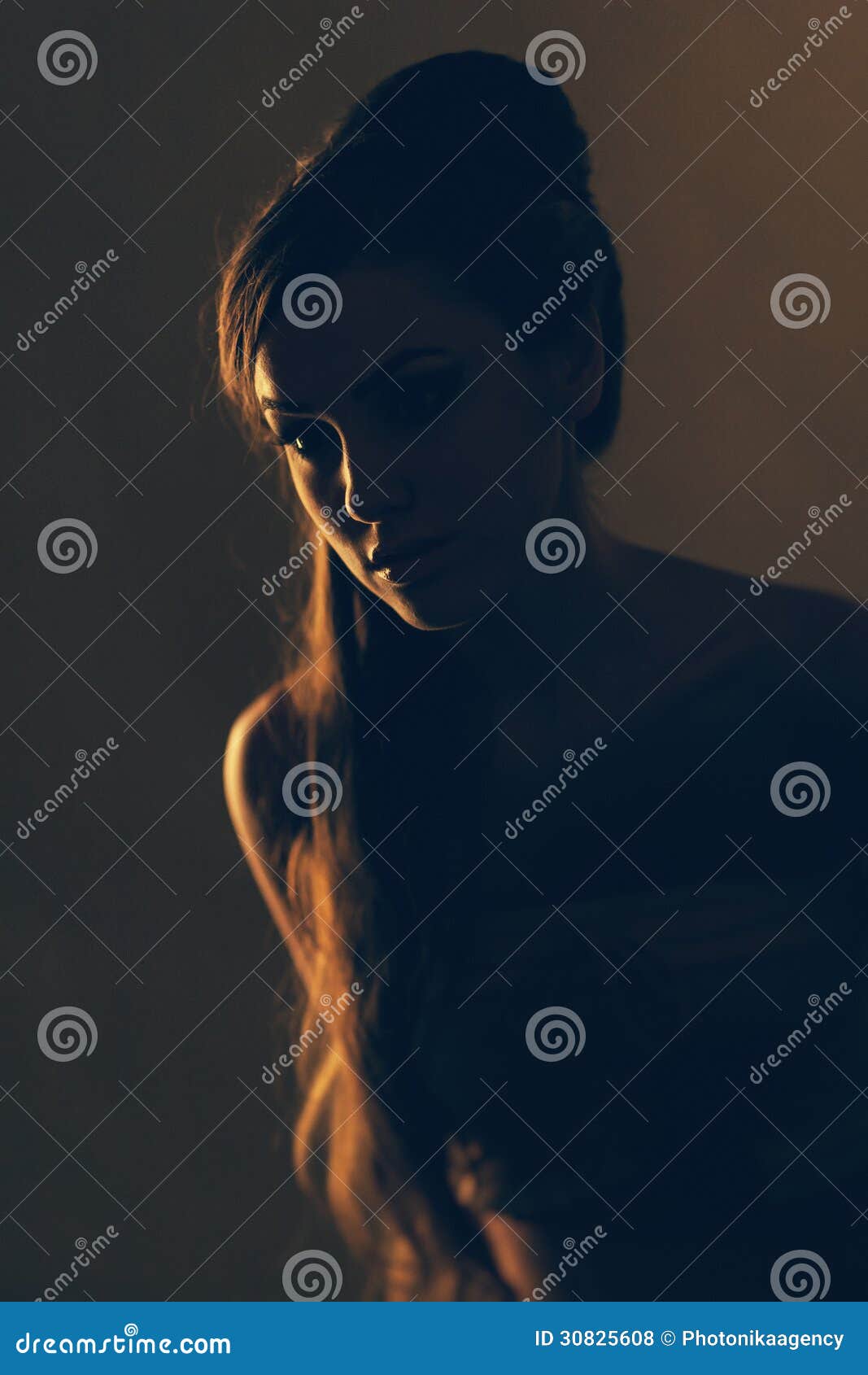 Portrait of Young Woman in Low Light Looking Down Stock Photo - Image ...