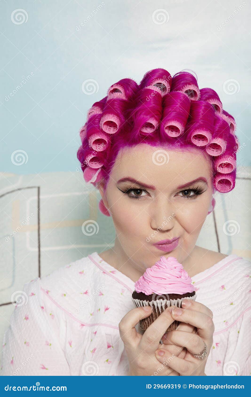 Portrait of a Young Woman Making Face while Holding Cupcake Stock Image ...