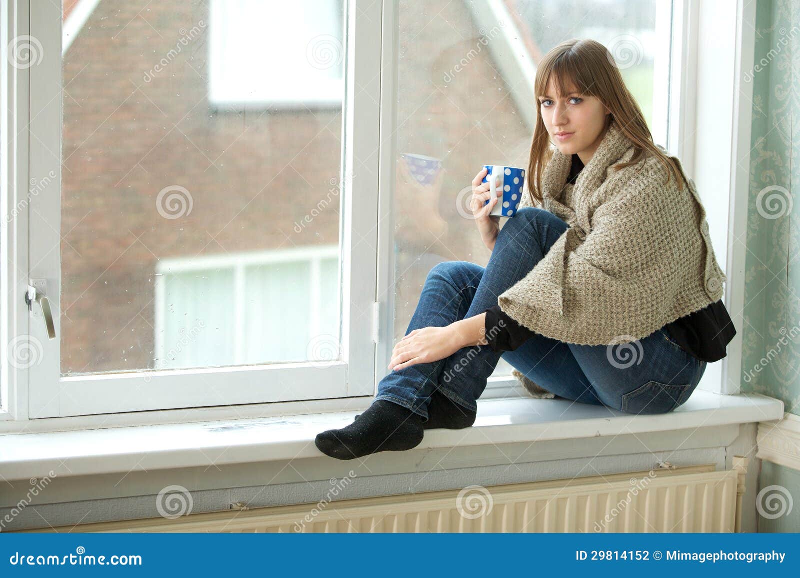 Young Woman Relaxing by Window with Cup of Tea Stock Photo - Image of ...