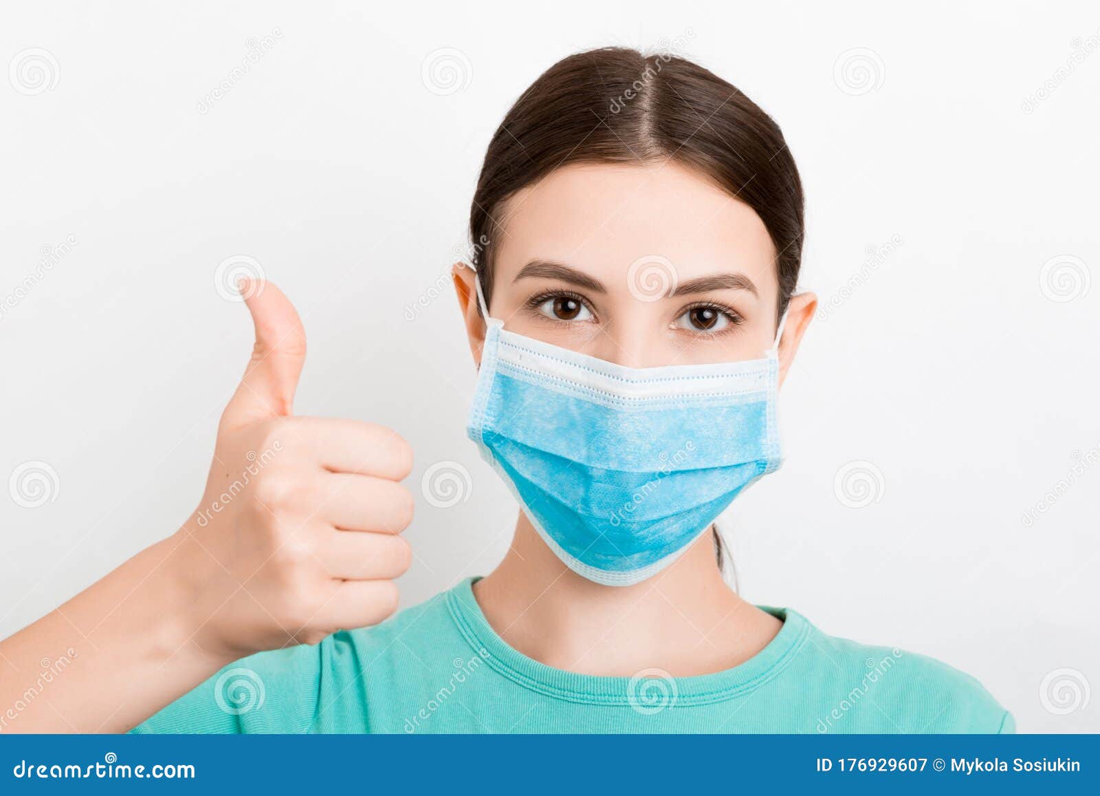 Portrait of Young Woman Wearing Medical Mask at White Background ... Portrait of Young Woman Wearing Medical Mask at White Background ...